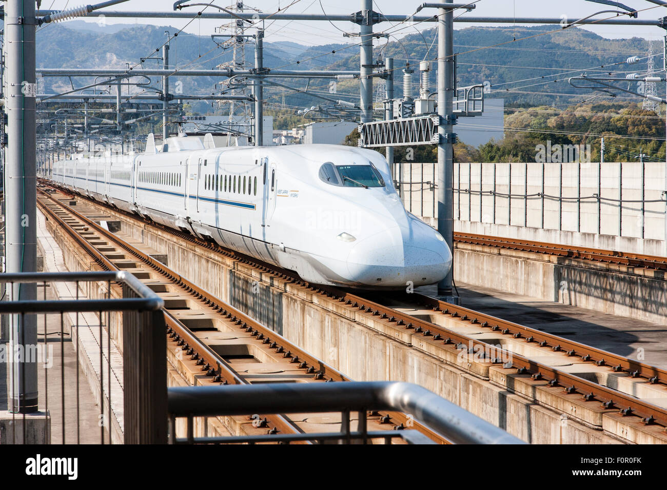 Japan, Shin-Tosu. A white with blue strip West Japan shinkansen, Bullet ...