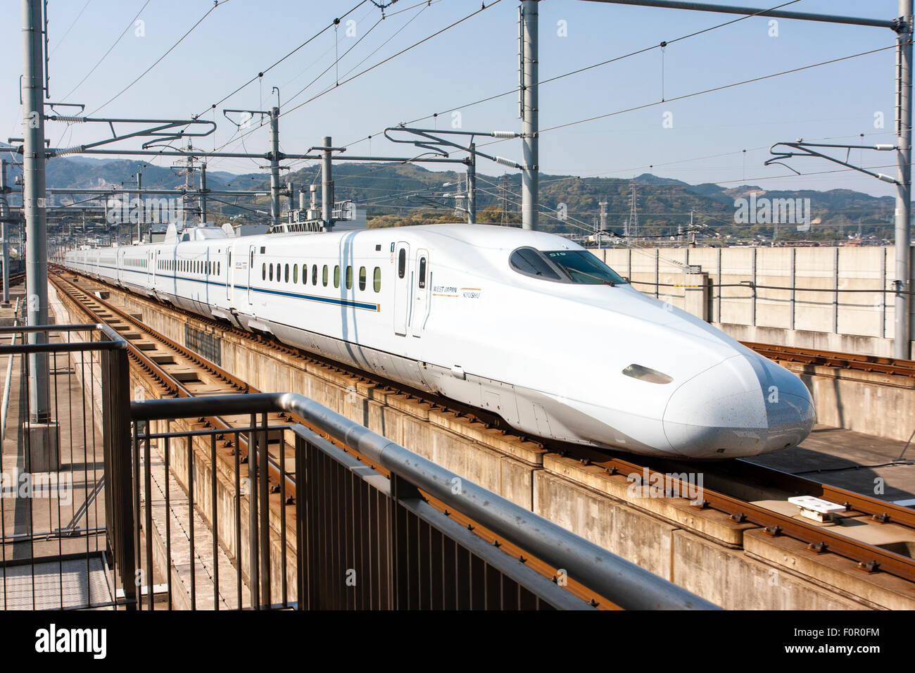 Japan, Shin-Tosu. A white with blue strip West Japan shinkansen, Bullet ...