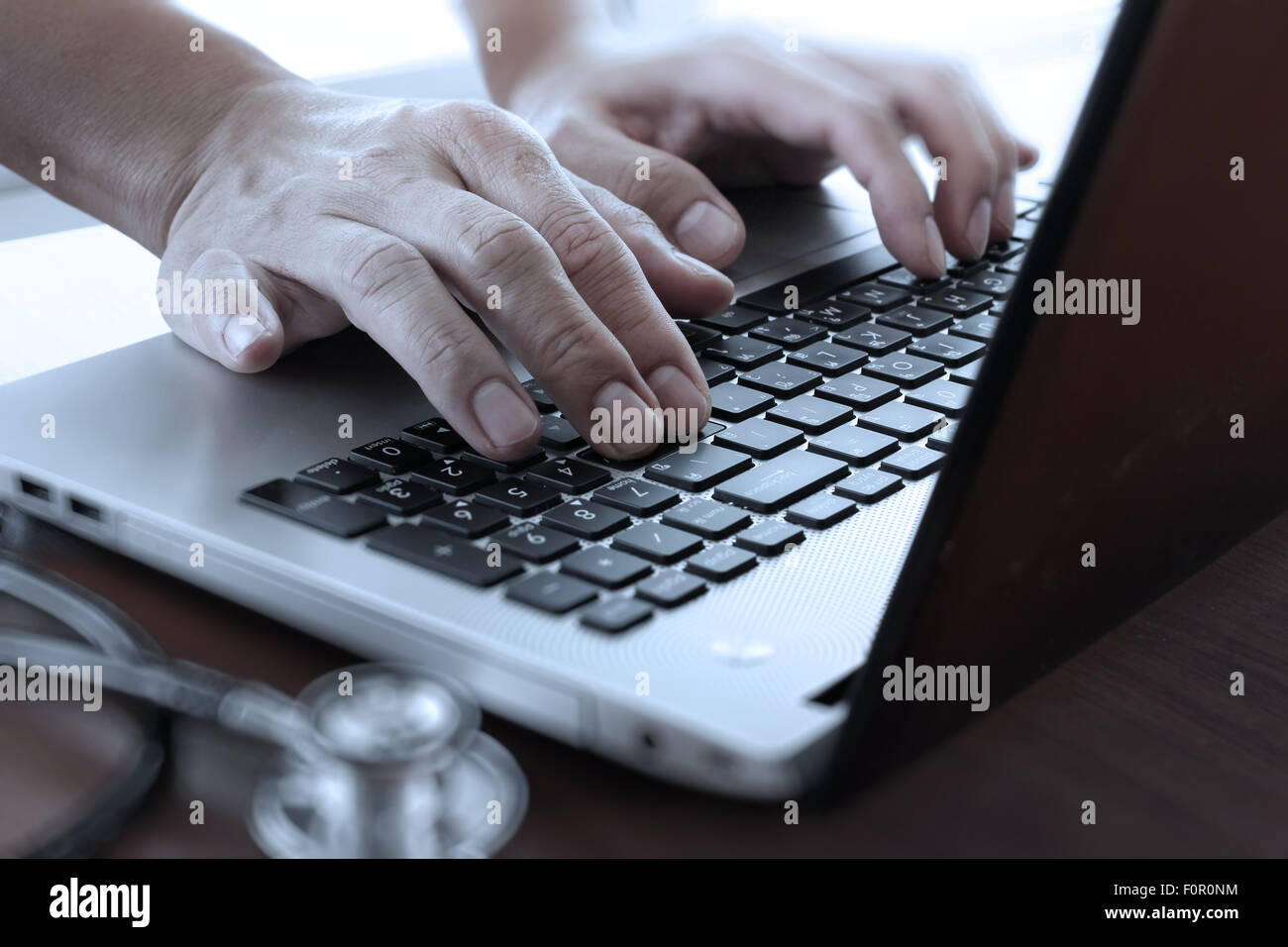 Doctor working with laptop computer in medical workspace office as ...