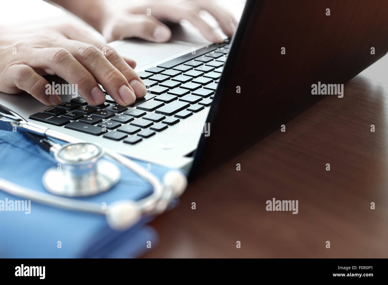 Doctor working with laptop computer in medical workspace office as ...