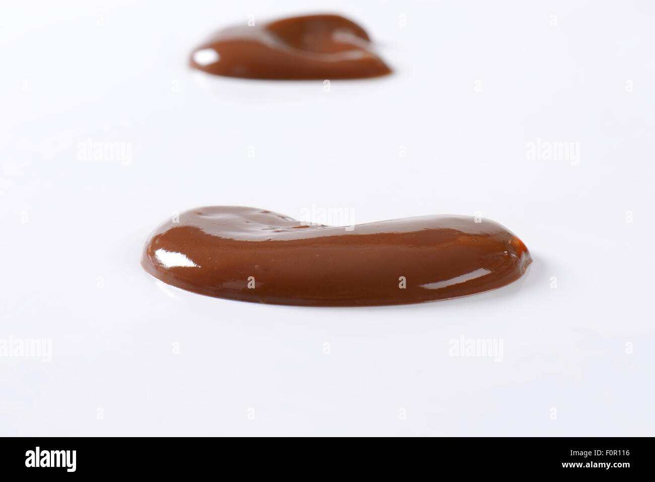 blobs of chocolate pudding on white background Stock Photo - Alamy