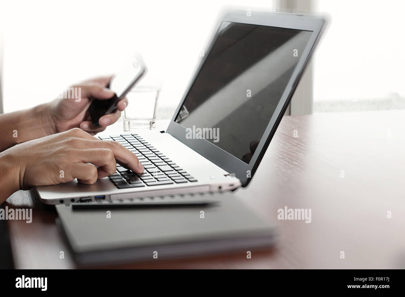 Close up of business man hand working on blank screen laptop computer ...
