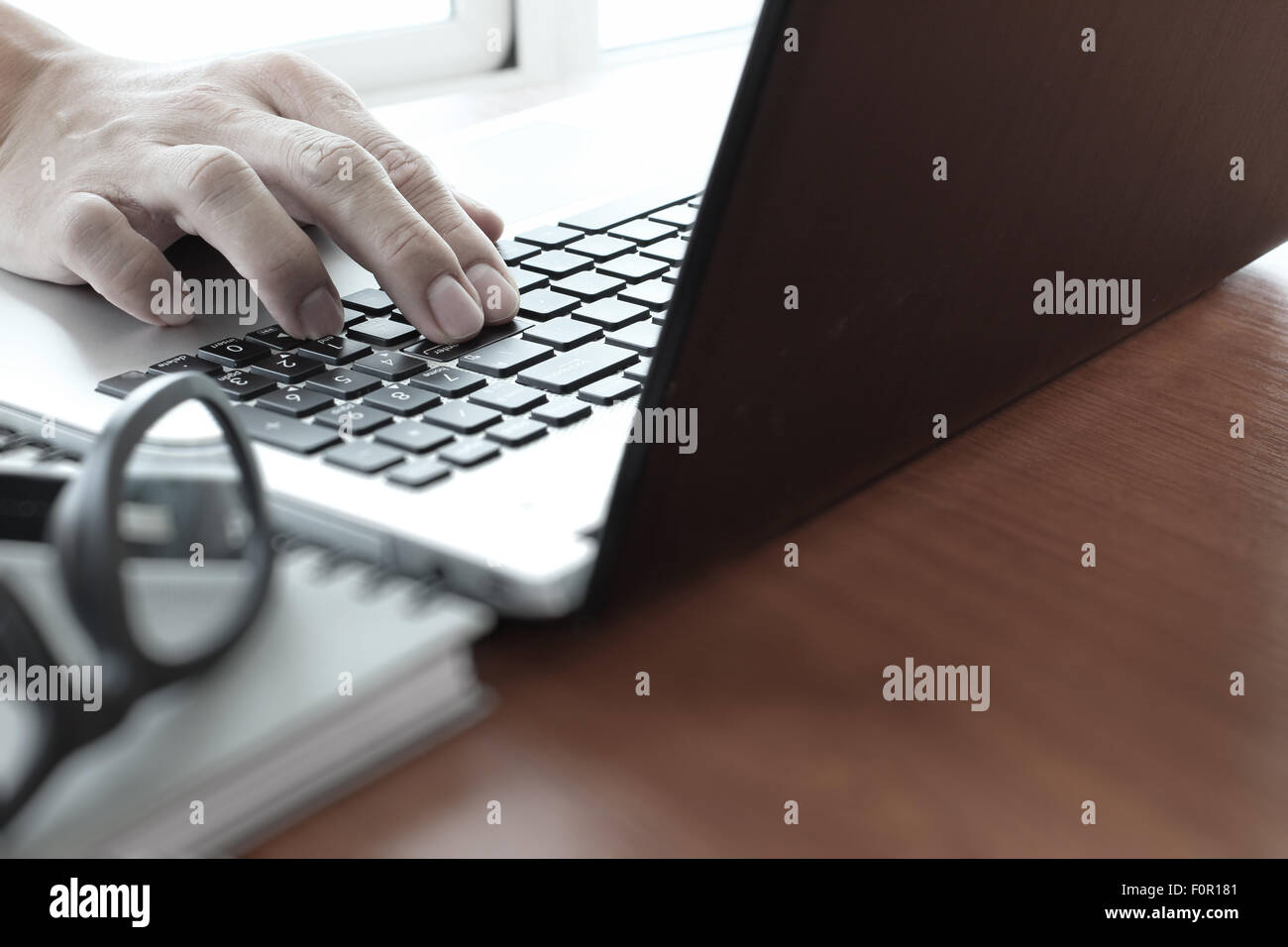 Close up of business man hand working on blank screen laptop computer ...