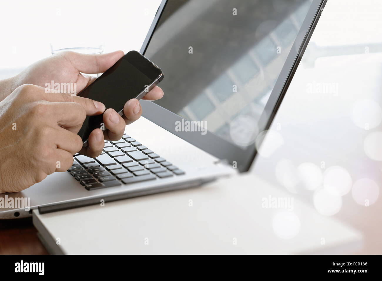 Close up of business man hand working on blank screen laptop computer ...