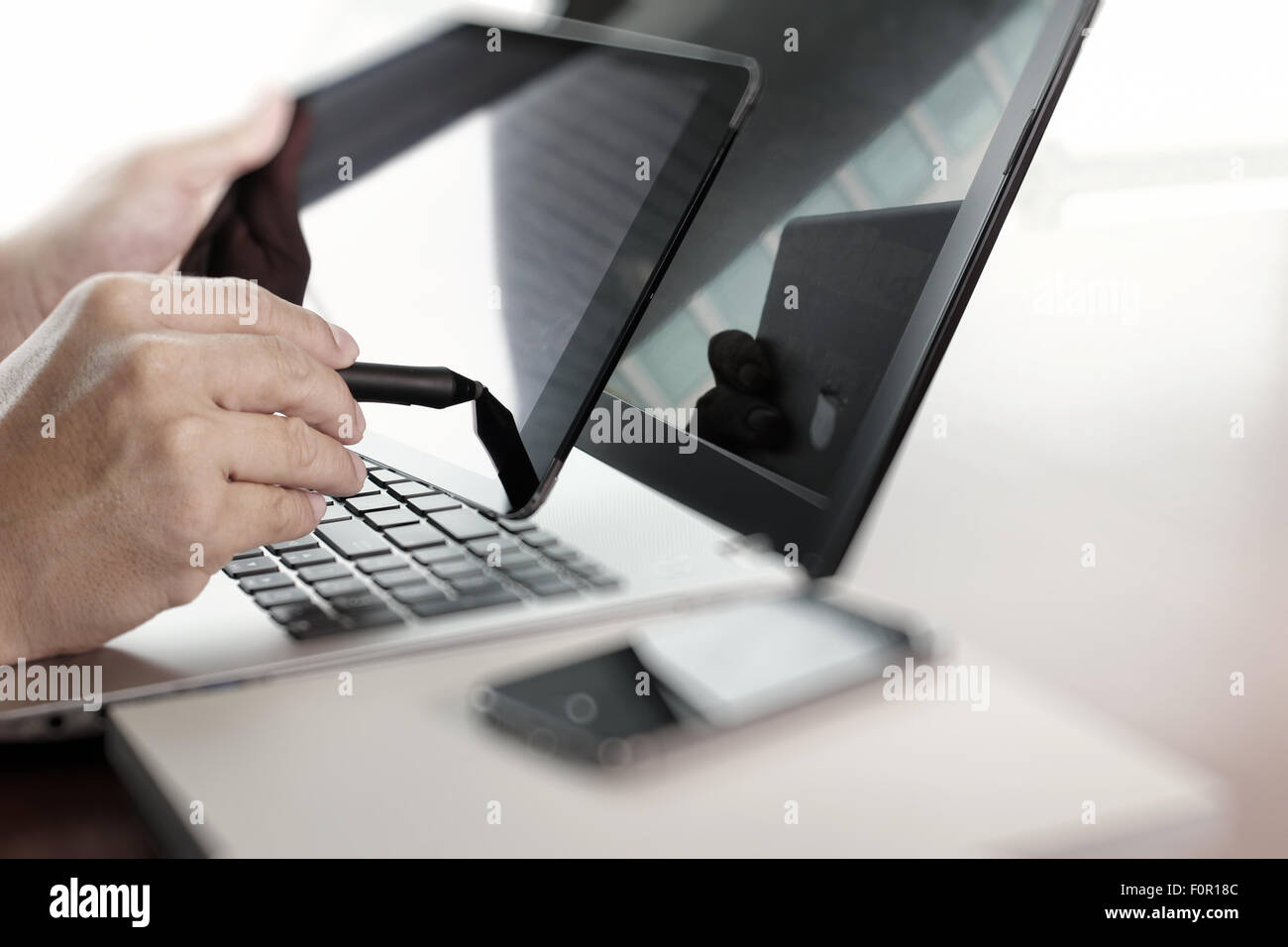 Close up of business man hand working on blank screen laptop computer ...