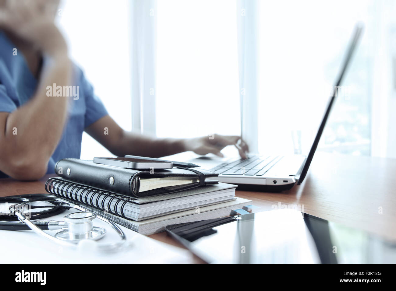 Doctor working with laptop computer in medical workspace office as ...