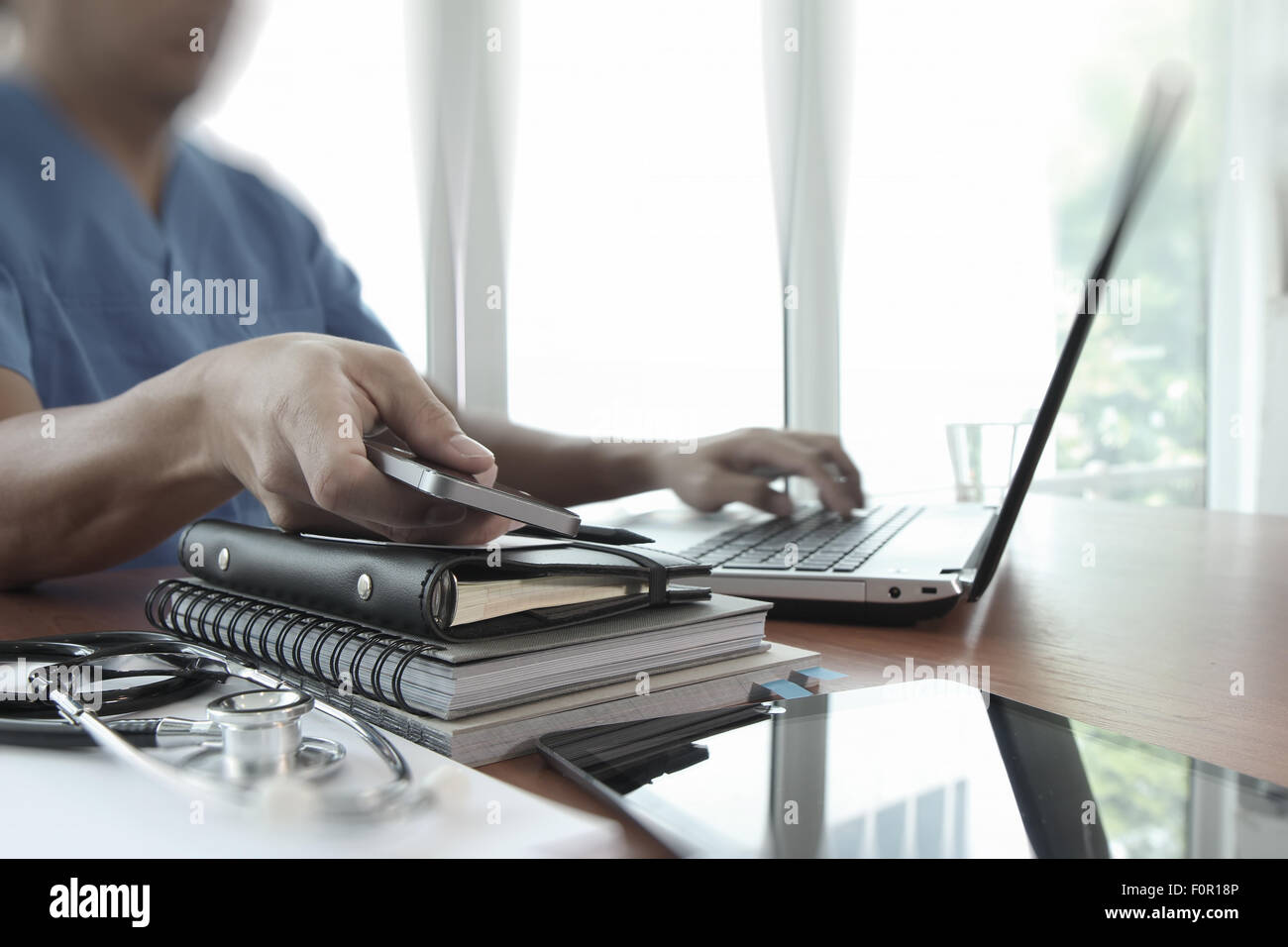 Doctor working with laptop computer in medical workspace office as ...