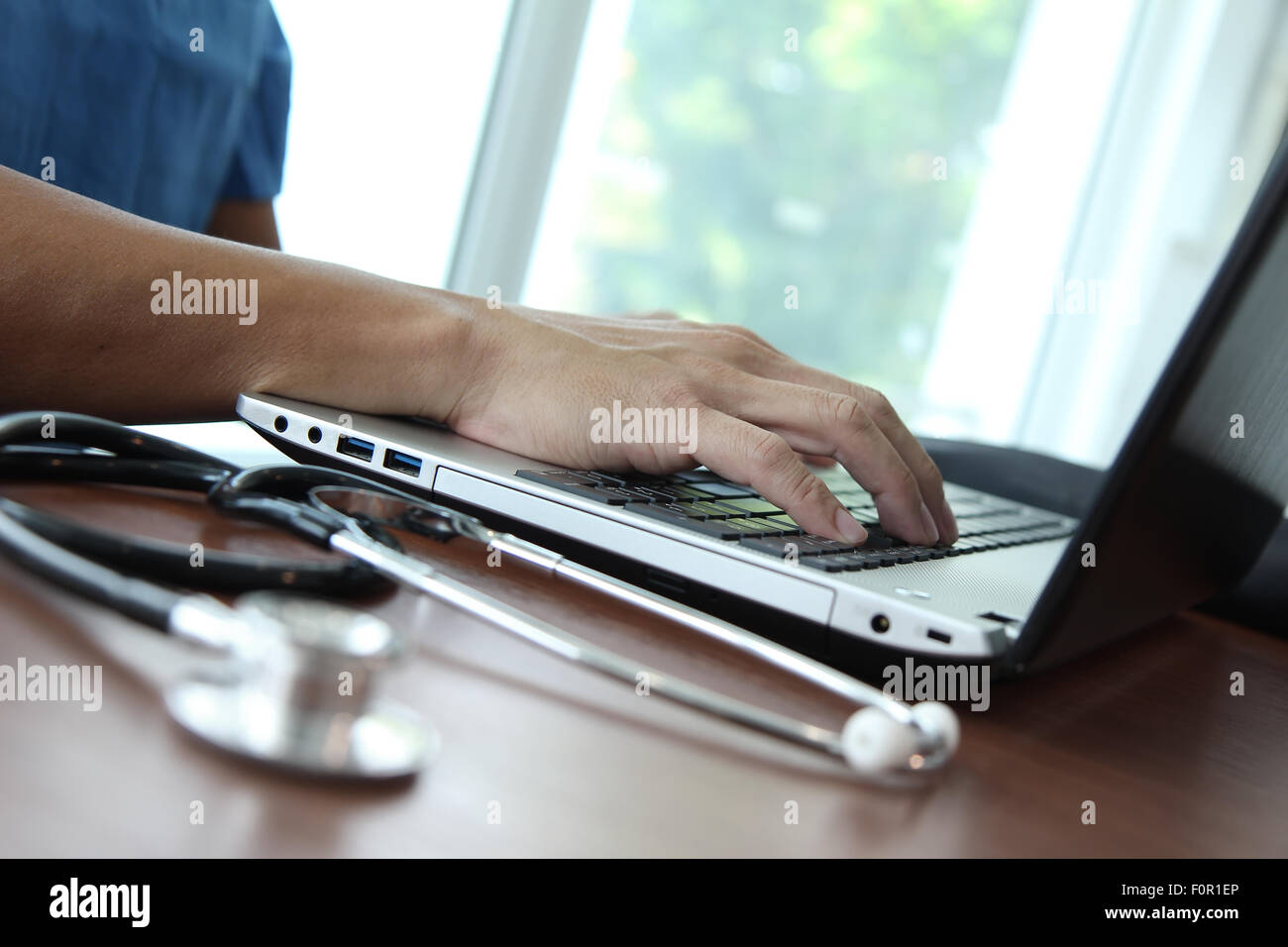 Doctor working with laptop computer in medical workspace office as ...