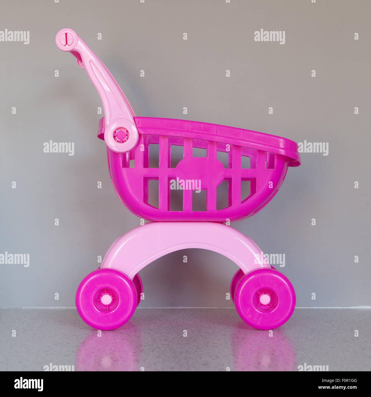 Pink shopping cart in a living room Stock Photo - Alamy