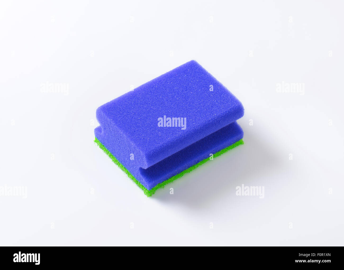 blue kitchen sponge on white background Stock Photo - Alamy