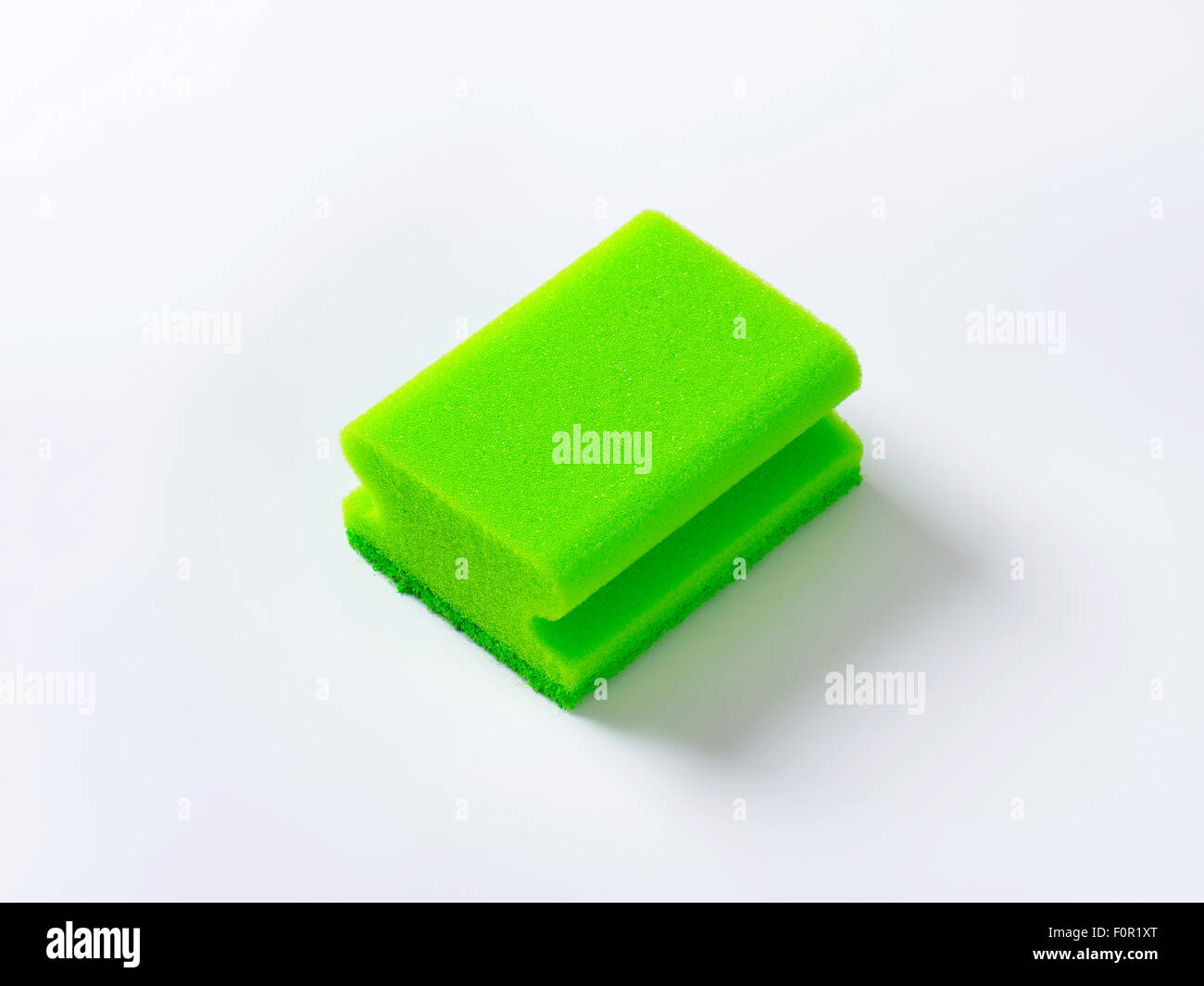 green kitchen sponge on white background Stock Photo - Alamy