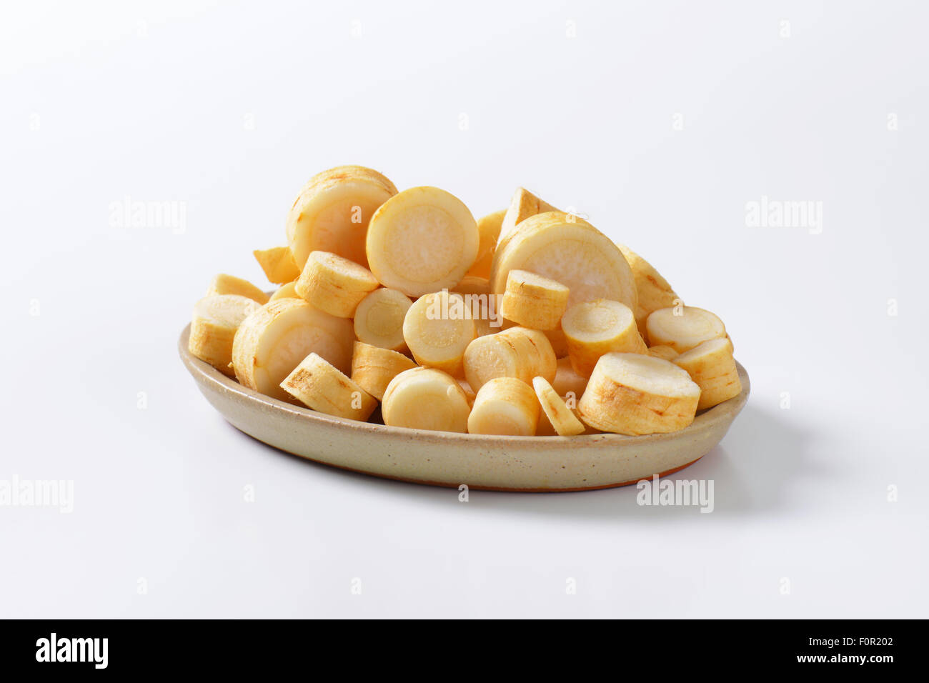 plate of sliced parsley root on white background Stock Photo - Alamy