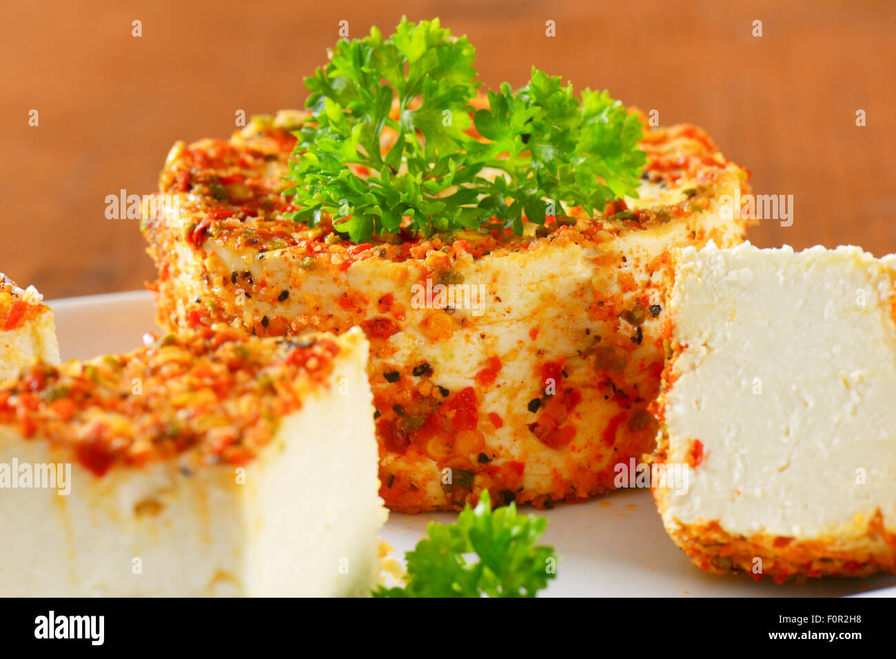 fresh cheese rolled in chili flakes Stock Photo - Alamy