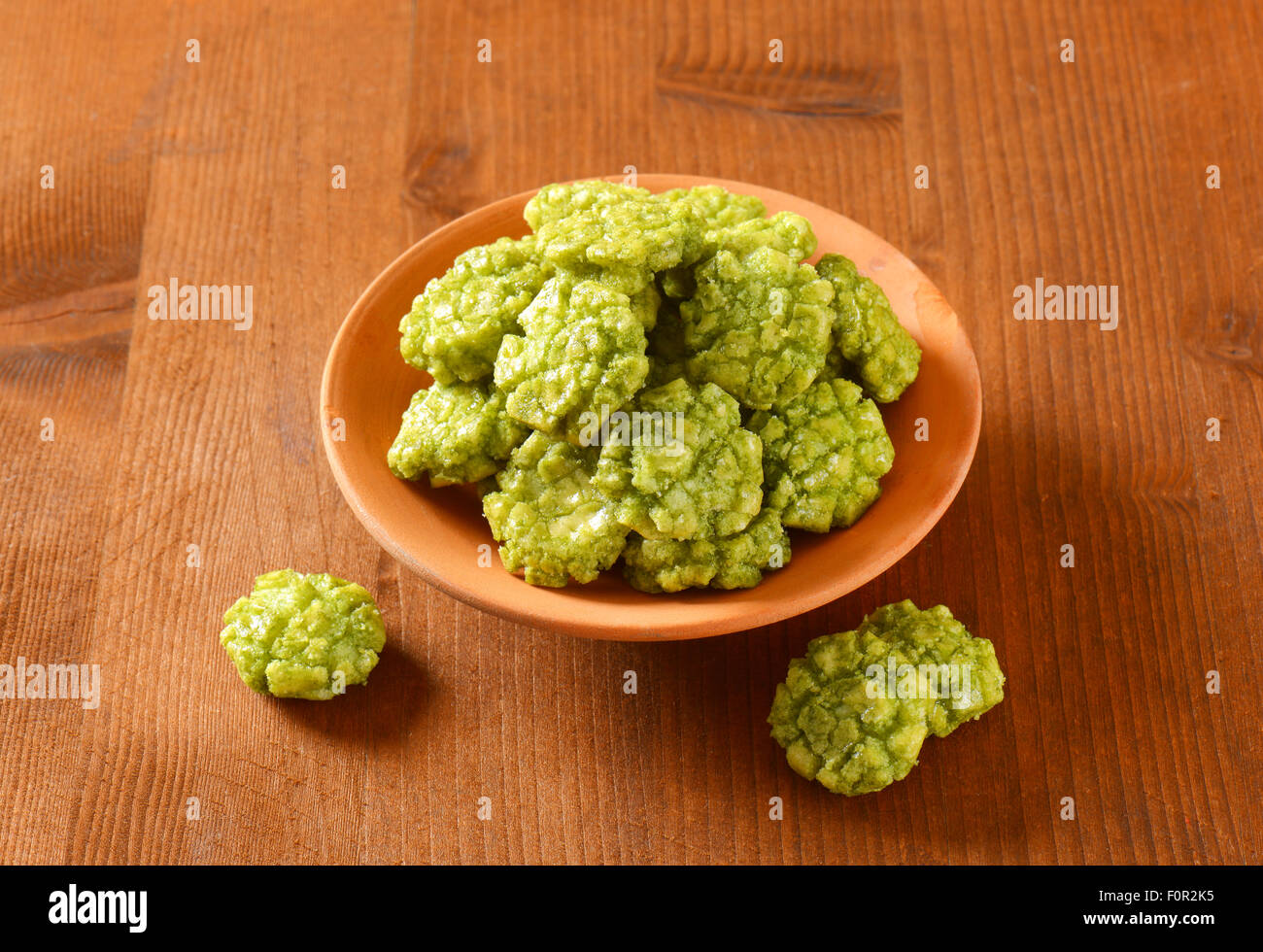 bowl of wasabi crackers on wooden table Stock Photo - Alamy