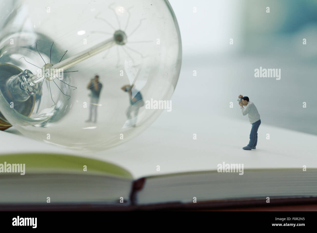 Creative idea concept - miniature photographer with vintage light bulb ...
