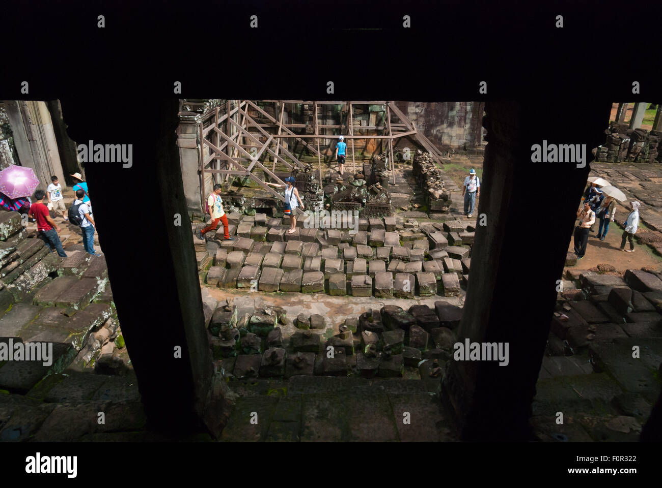 Tourists passing through ongoing restoration project in Angkor Stock ...