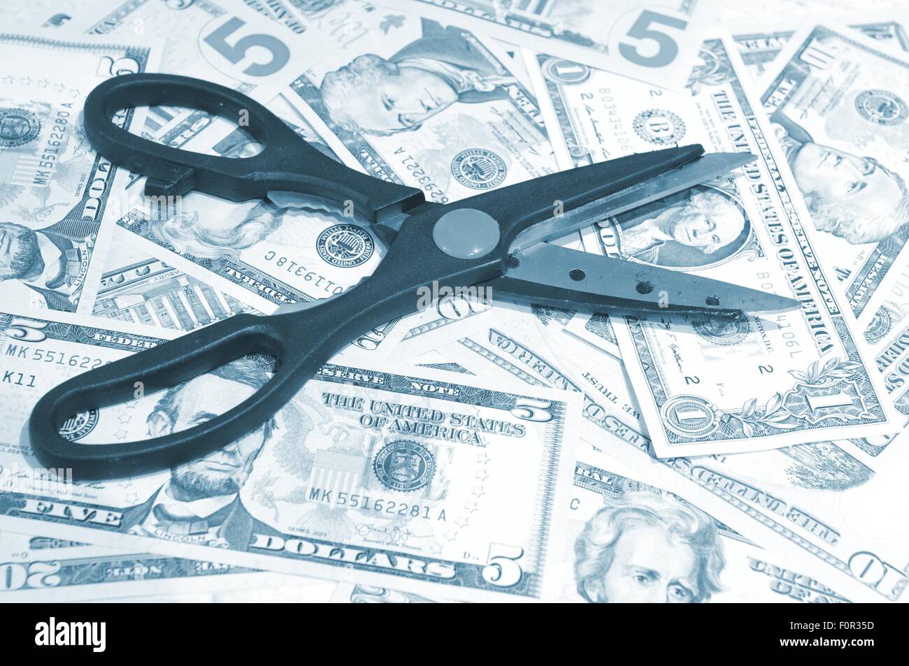 Dollars scissors money cutting hi-res stock photography and images - Alamy