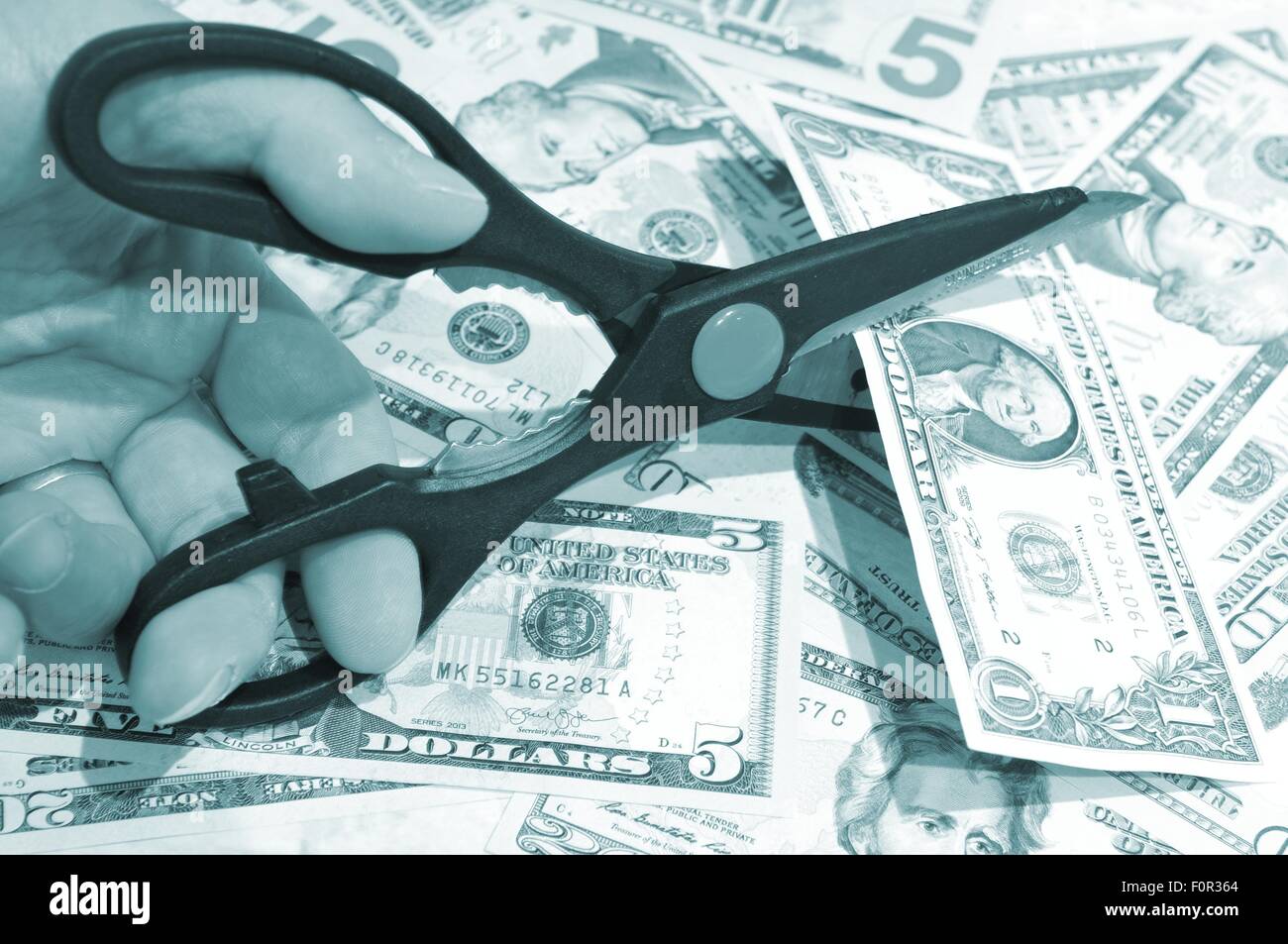 Budget cut concept with scissors and US dollars Stock Photo - Alamy