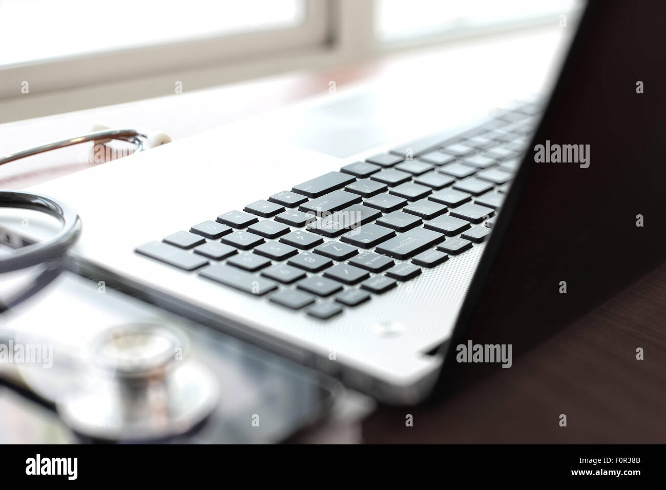 Doctor working with laptop computer in medical workspace office as ...