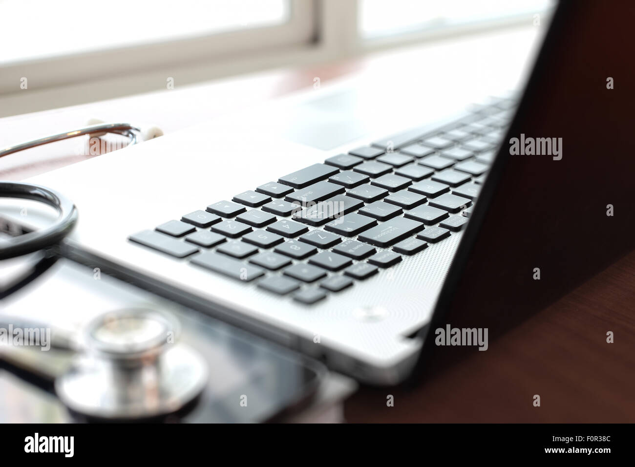 Doctor working with laptop computer in medical workspace office as ...