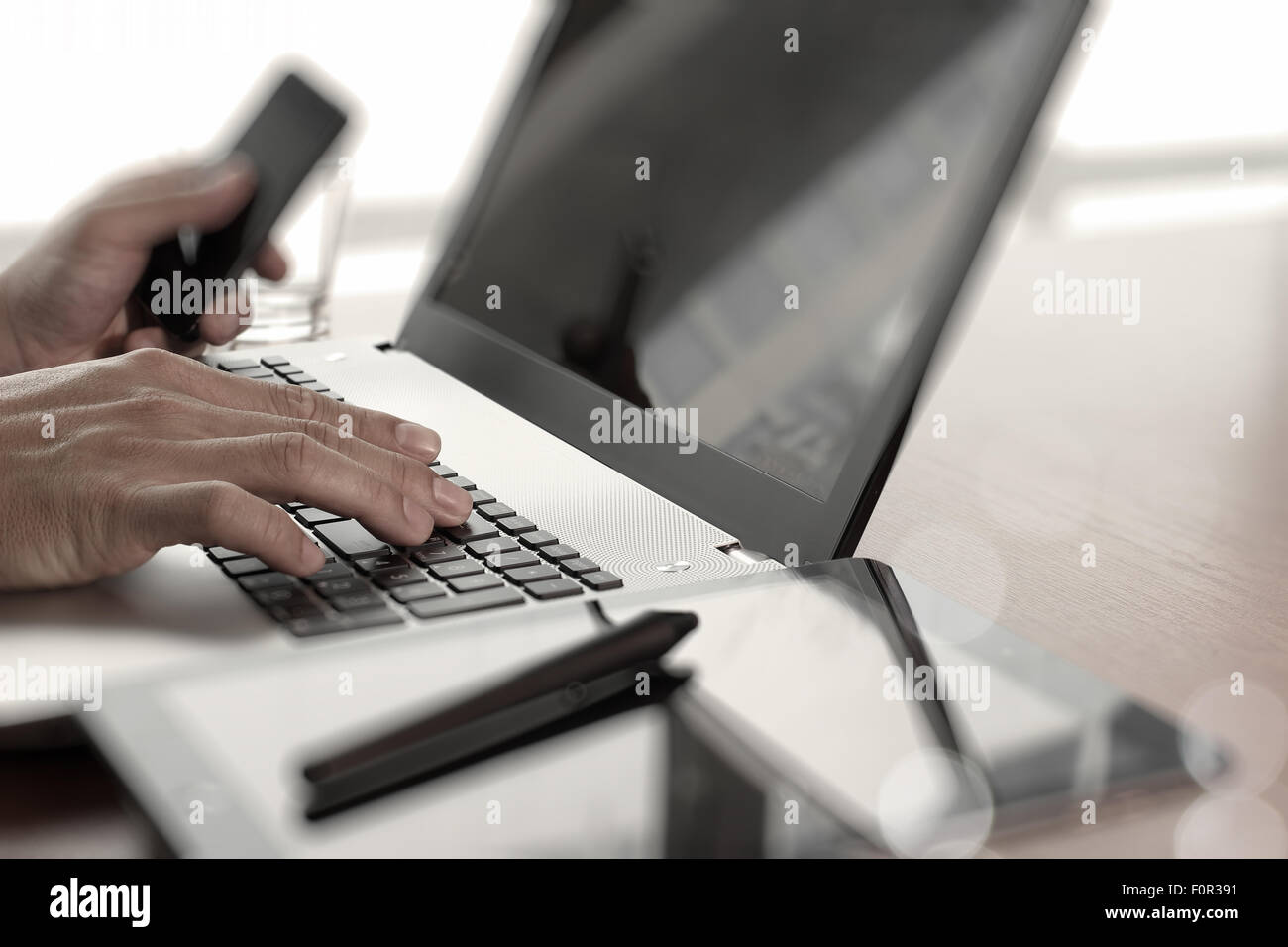 Close up of business man hand working on blank screen laptop computer ...