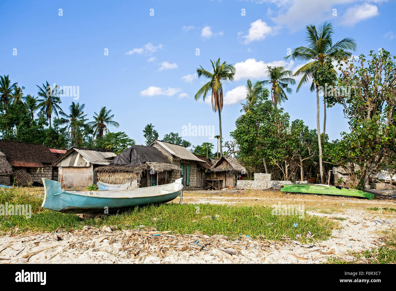 traditional indonesian poor house - cabin with boat on beach, Nusa ...