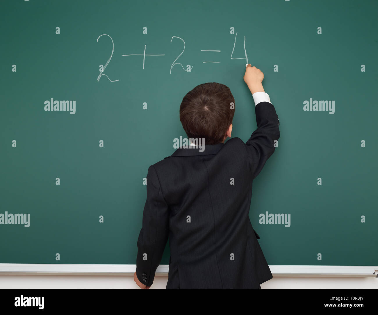 School boy solve math on the school board Stock Photo - Alamy