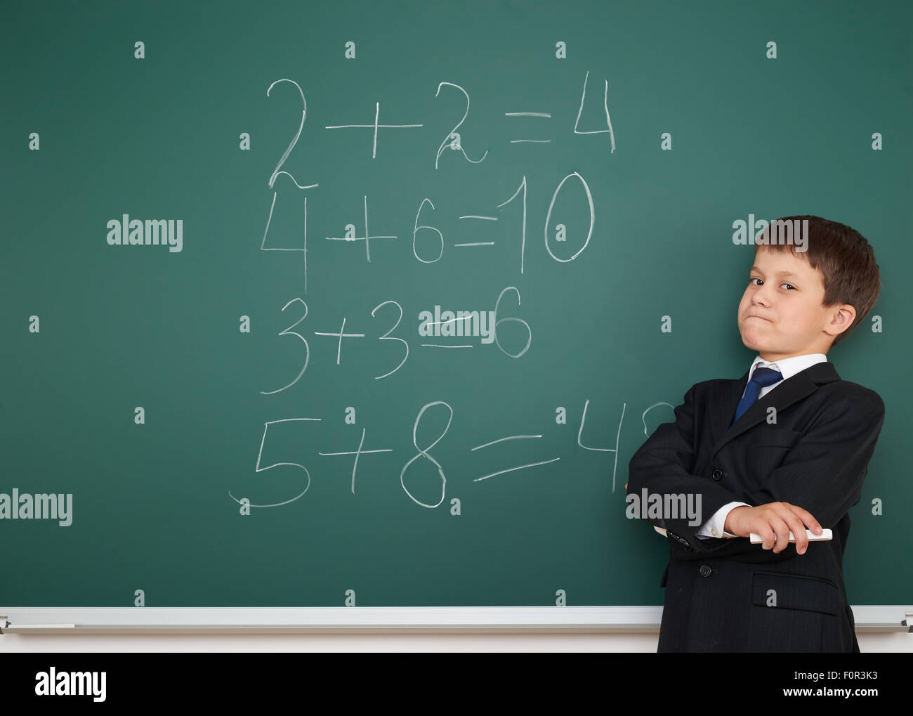 School boy solve math on the school board Stock Photo - Alamy