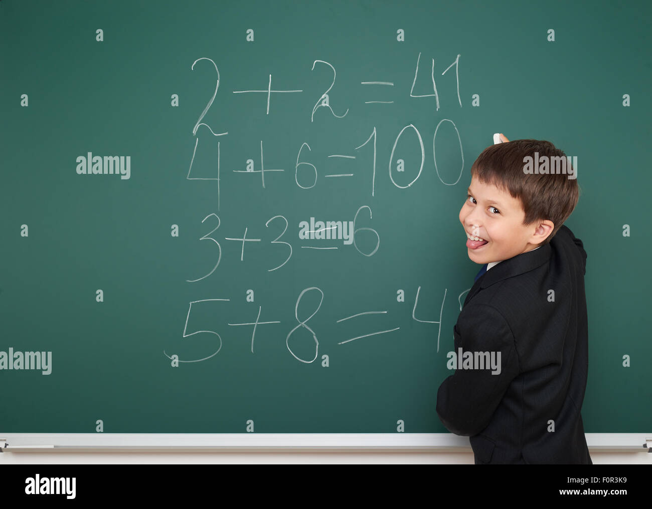 School boy solve math on the school board Stock Photo - Alamy