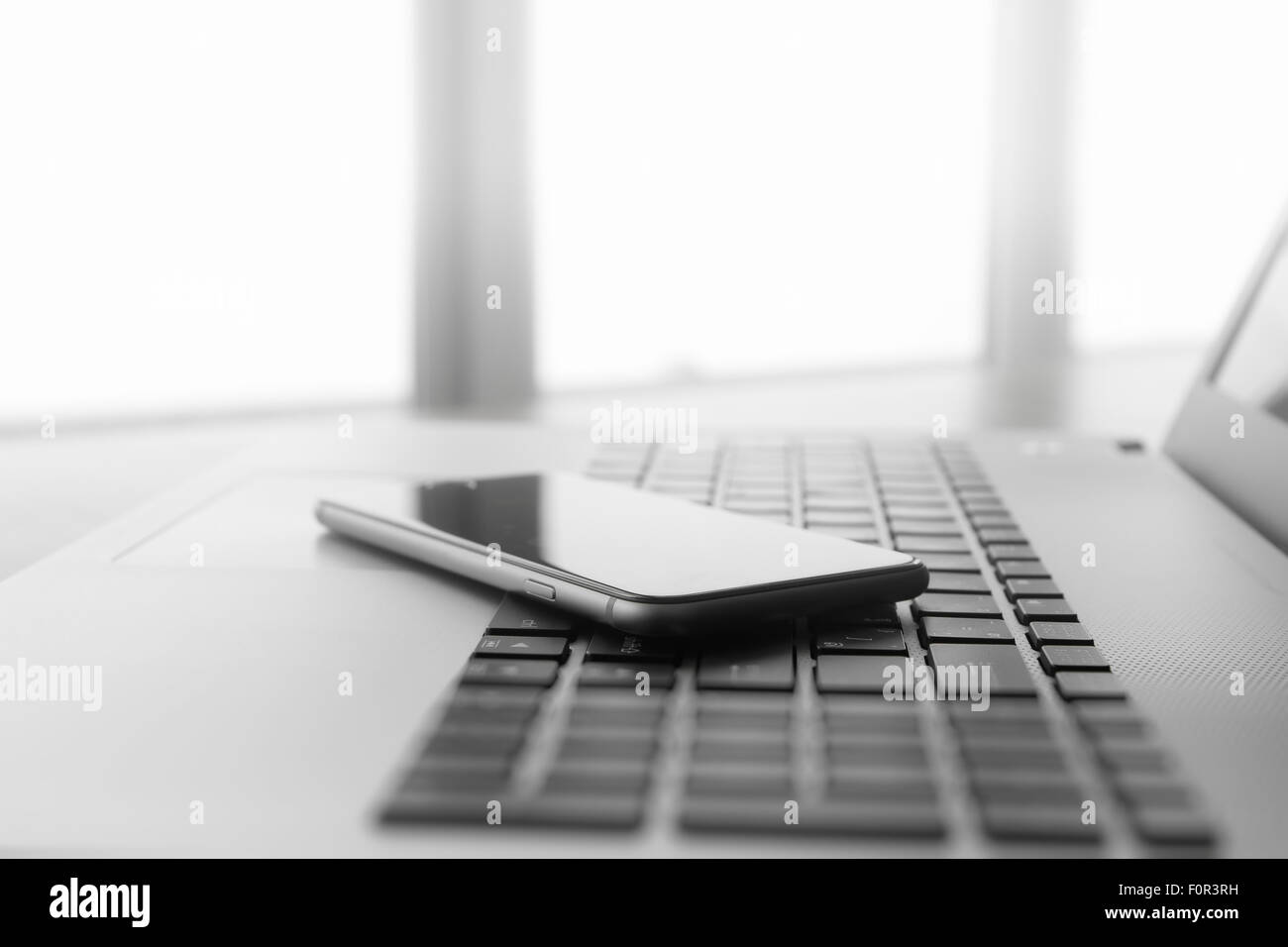 Businessman hand using laptop and mobile phone in office Stock Photo ...