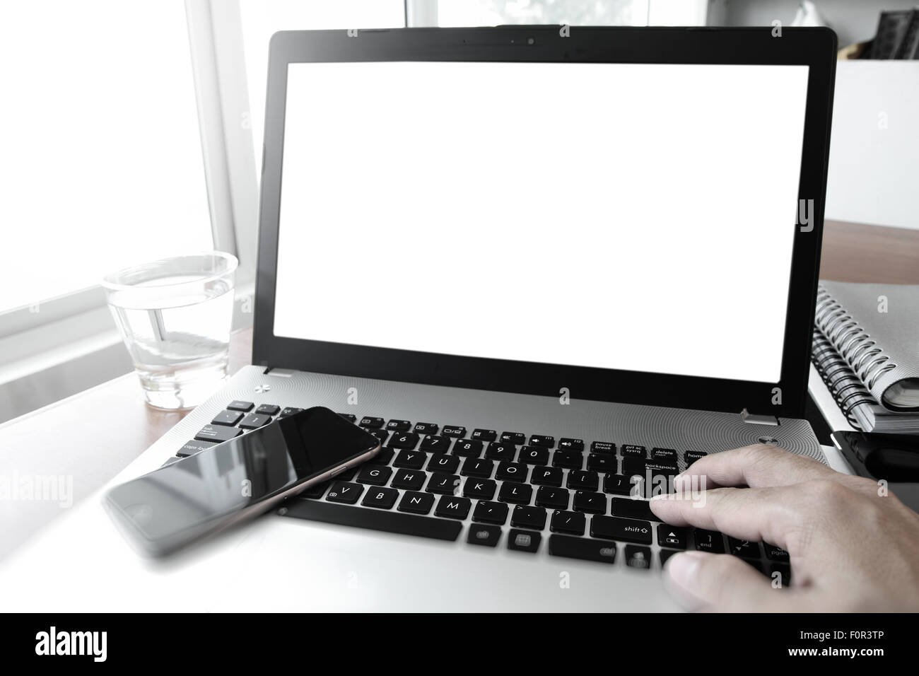 Close up of business man hand working on blank screen laptop computer ...