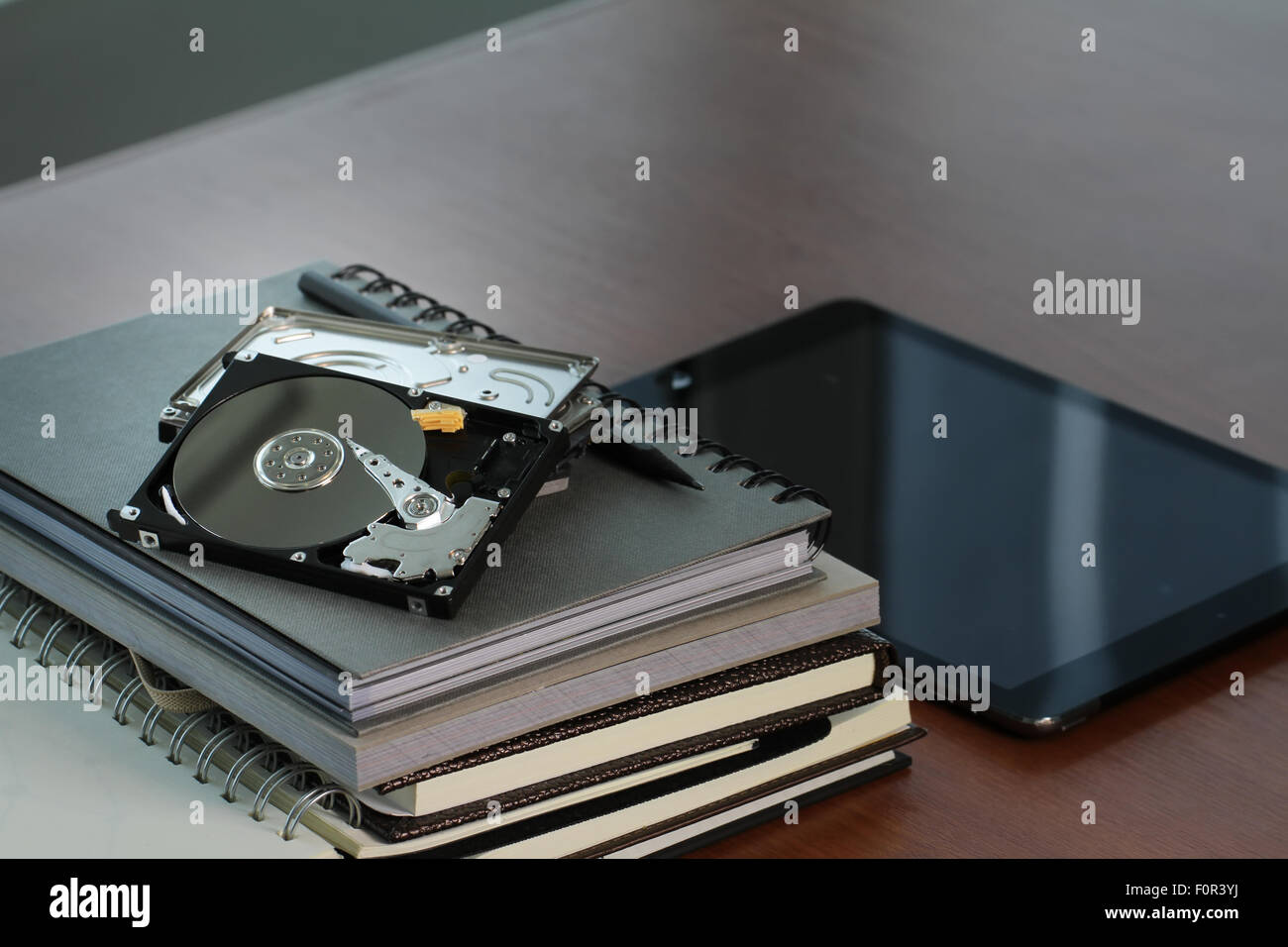Close up of open computer hard disk drive on desk and notebook Stock ...