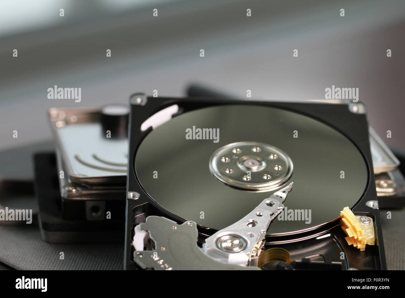 Close up of open computer hard disk drive on desk and notebook Stock ...