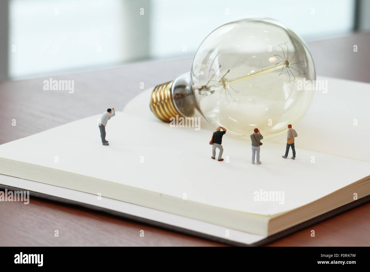 Creative idea concept - miniature photographer with vintage light bulb ...