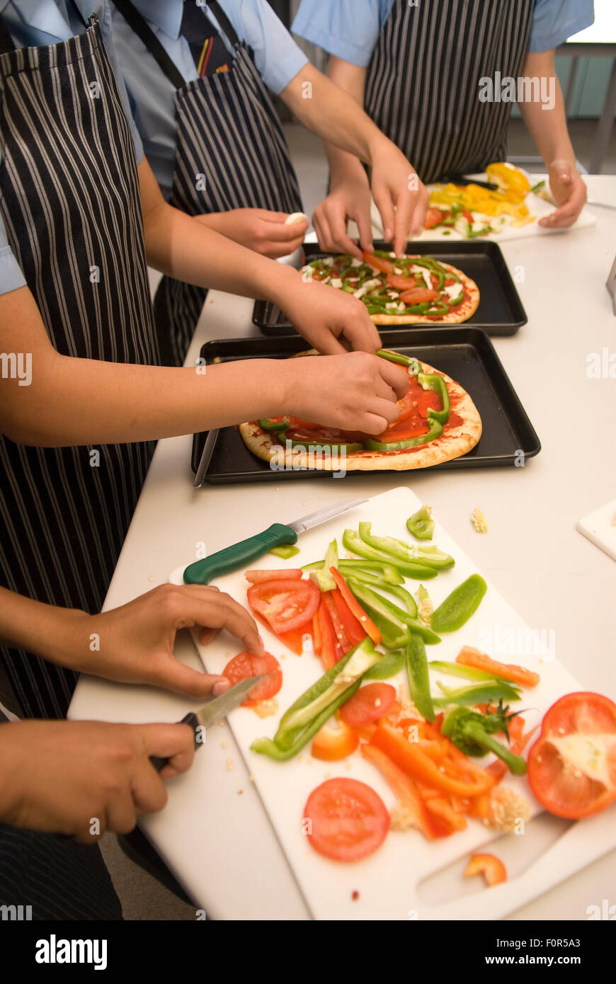 Secondary school pupil's preparing healthy ingredients in a cookery ...