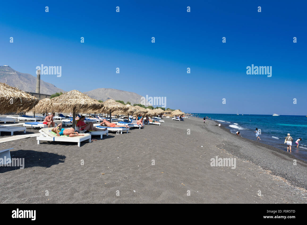 Perissa beach, one of Santorini popular beaches with black sand, Greece ...