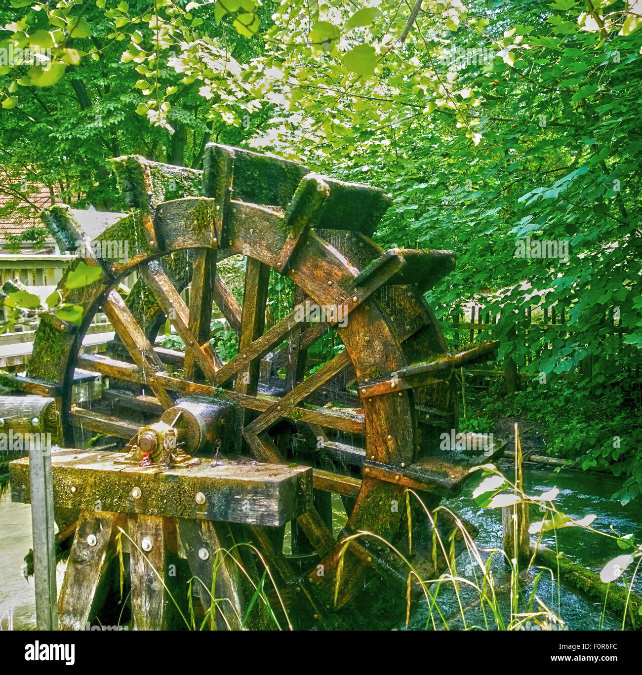 vintage wooden mill wheel running in the waters of a small river Stock ...