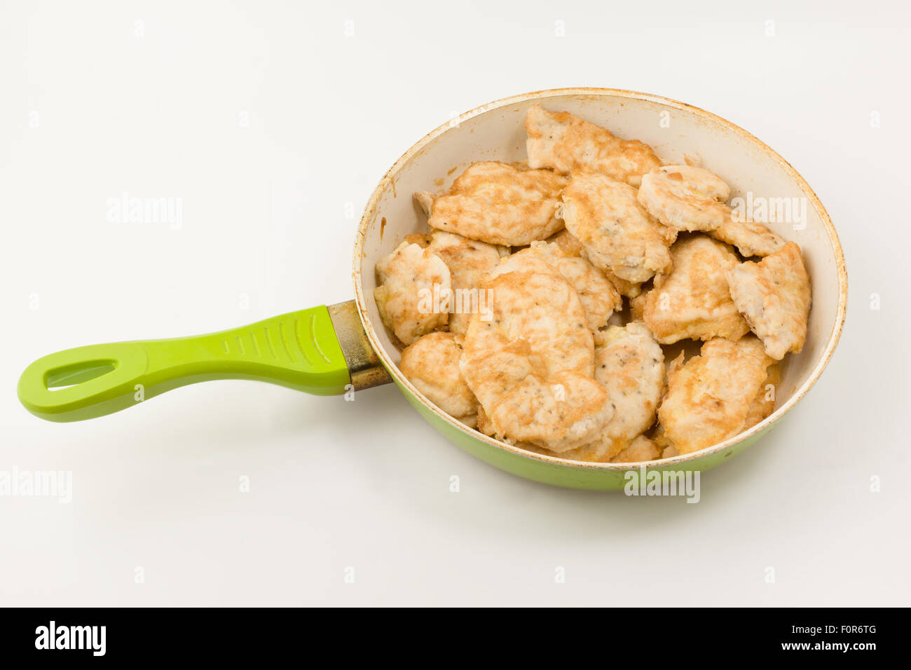 fried meat with seasonings lies in a white frying pan Stock Photo - Alamy