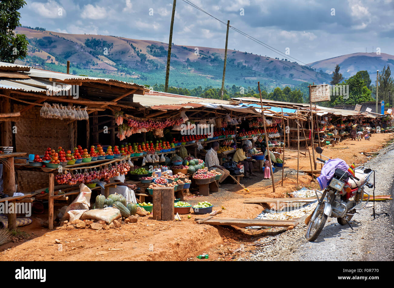 market stalls with fruits and vegetables beneath the road, Uganda ...