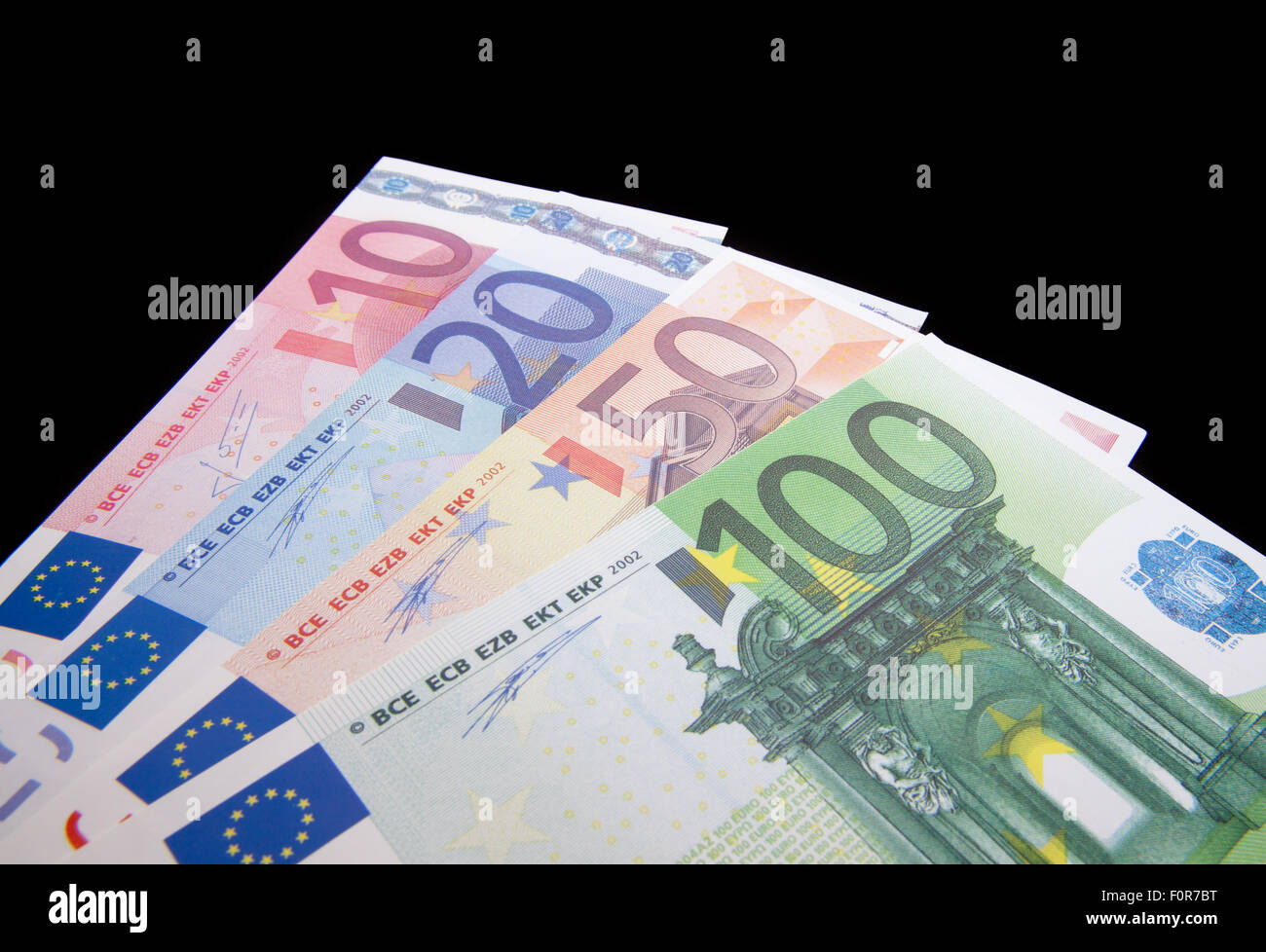 Various euro notes isolated on black background Stock Photo - Alamy