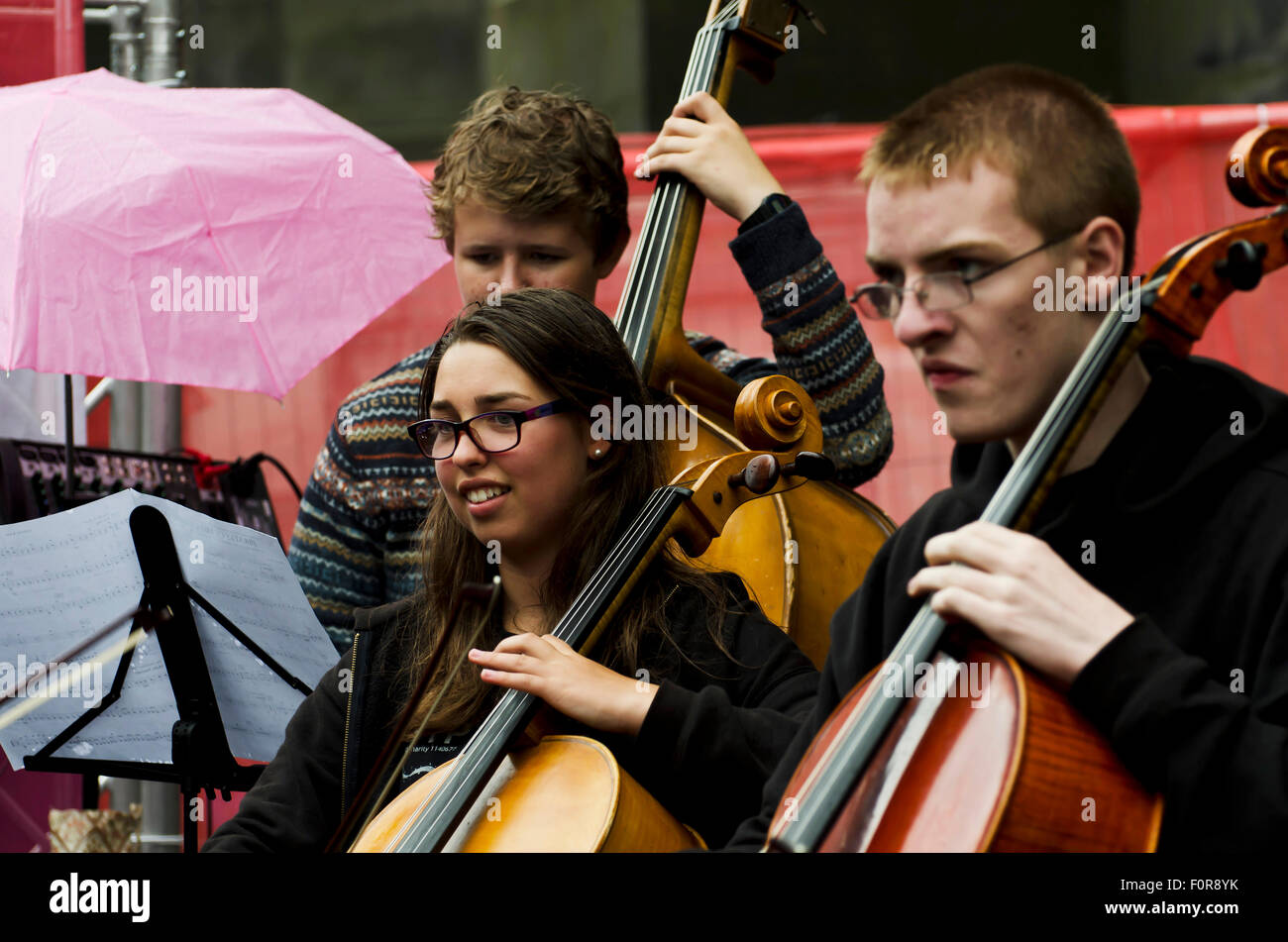 Three musicians playing with a youth string orchestra at the Edinburgh ...