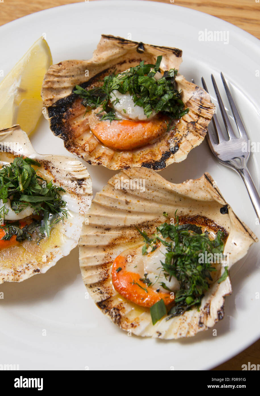 Wood roast scallops with sweet herbs and garlic butter Stock Photo - Alamy