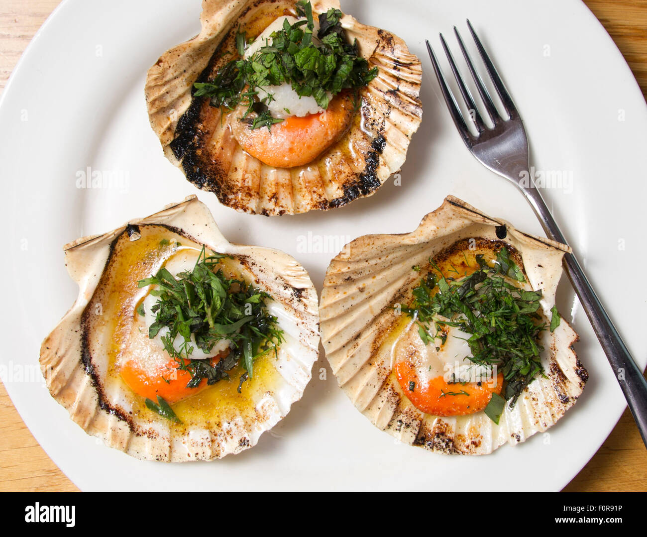 Wood roast scallops with sweet herbs and garlic butter Stock Photo - Alamy