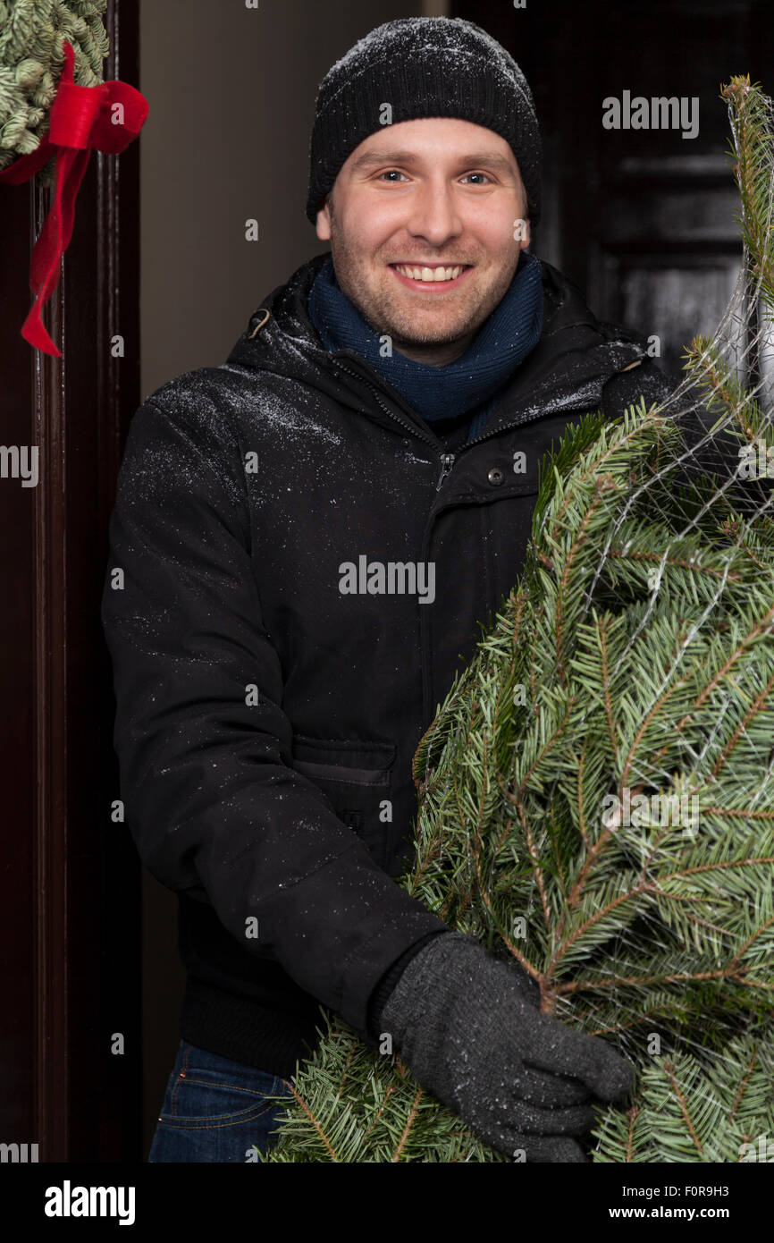 man with christmas tree Stock Photo - Alamy