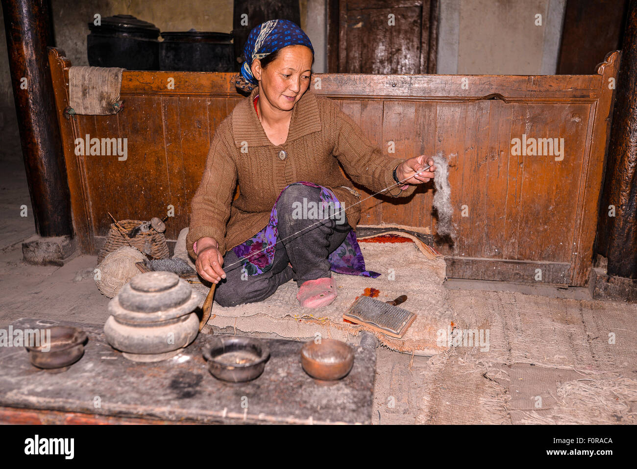 India Jammu Kashmir Ladakh A woman spinning wool in a traditional ...