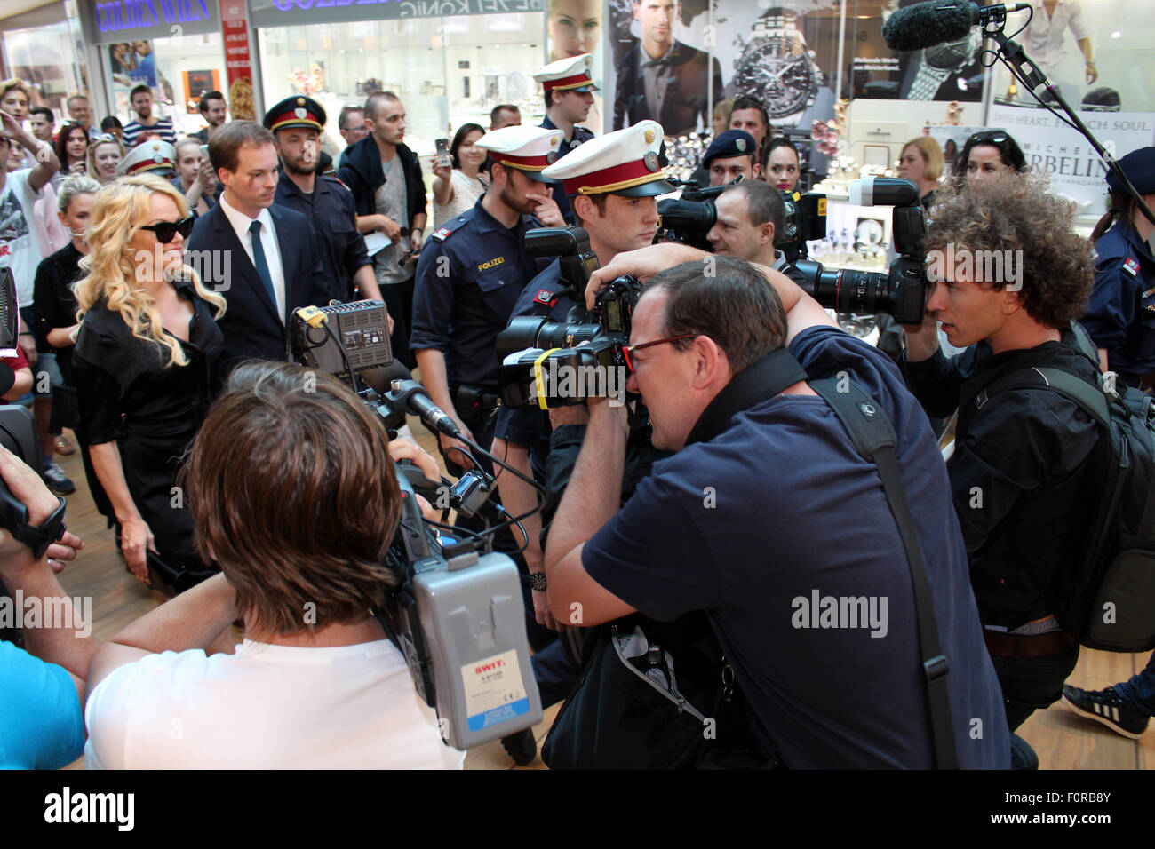 Pamela Anderson attends a charity shopping event at the shopping mall ...