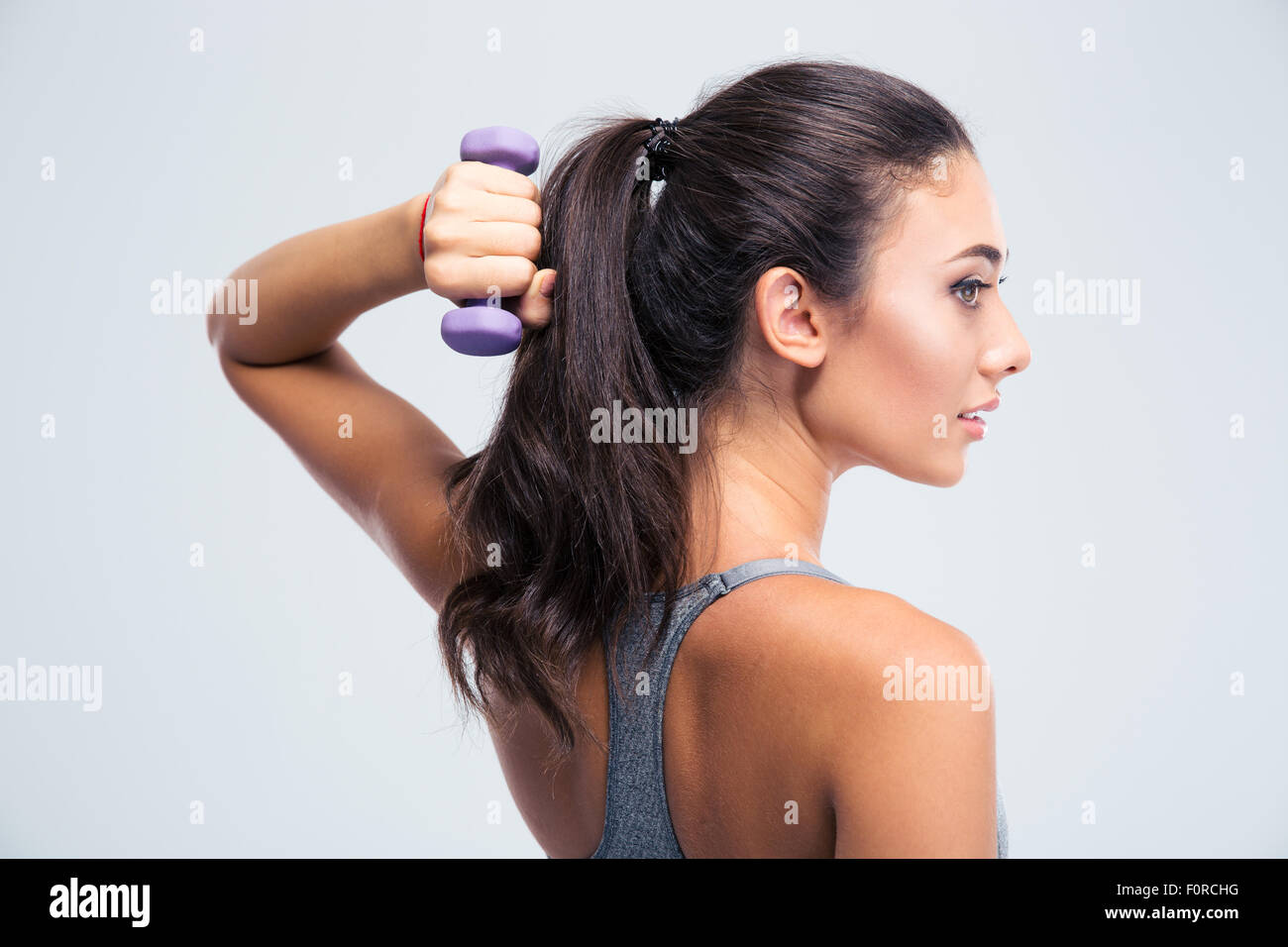 Side view portrait of a beautiful sports woman working out with ...