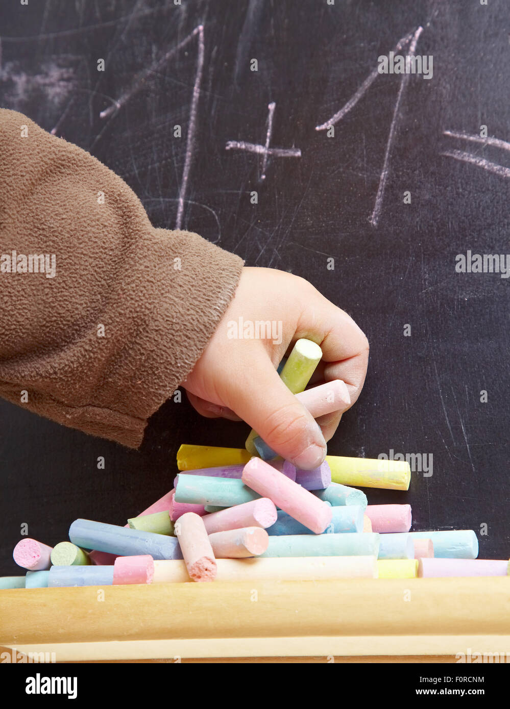 Children hand putting chalk to a blackboard Stock Photo - Alamy