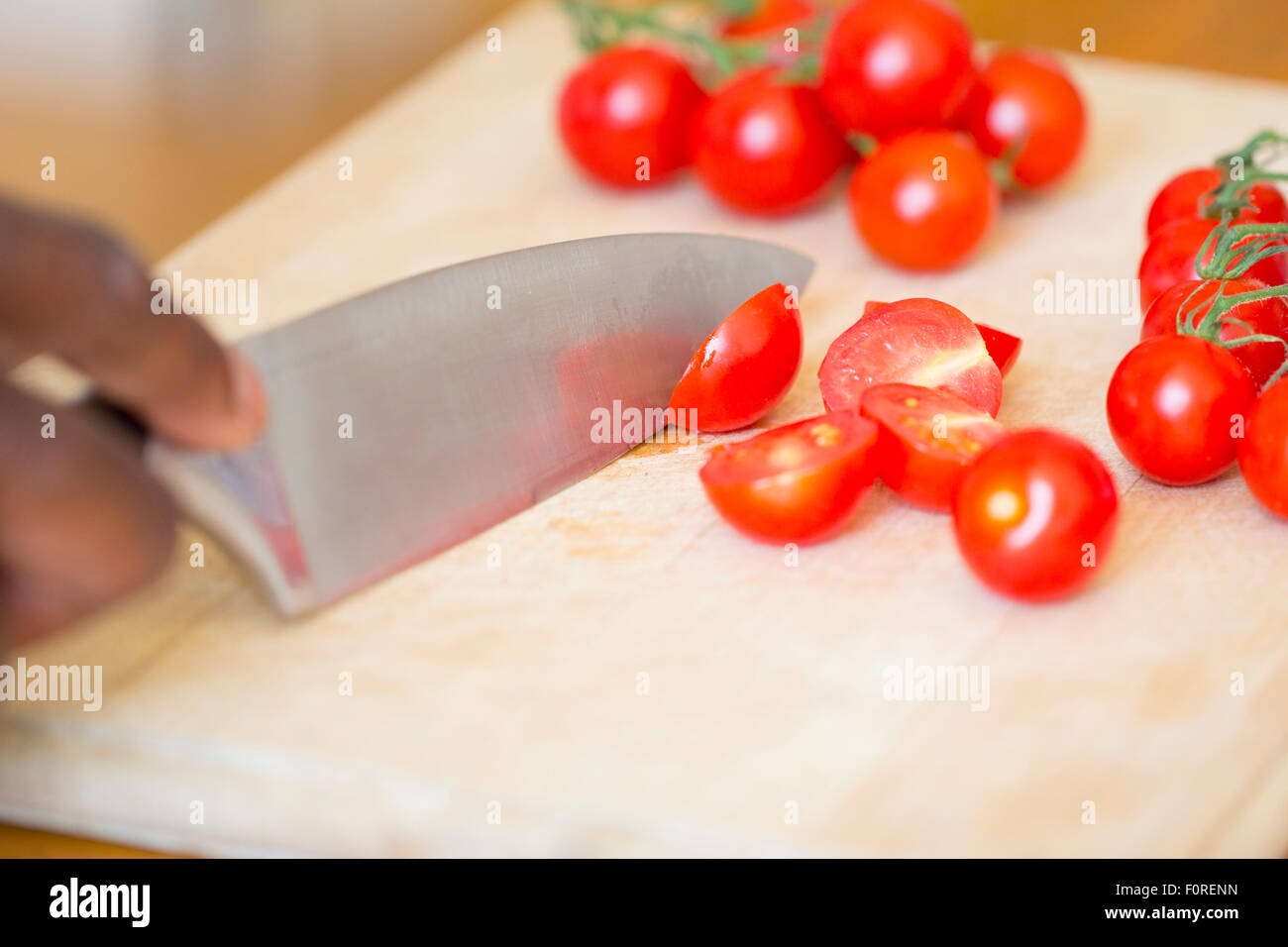 Chopping tomatoes hi-res stock photography and images - Alamy