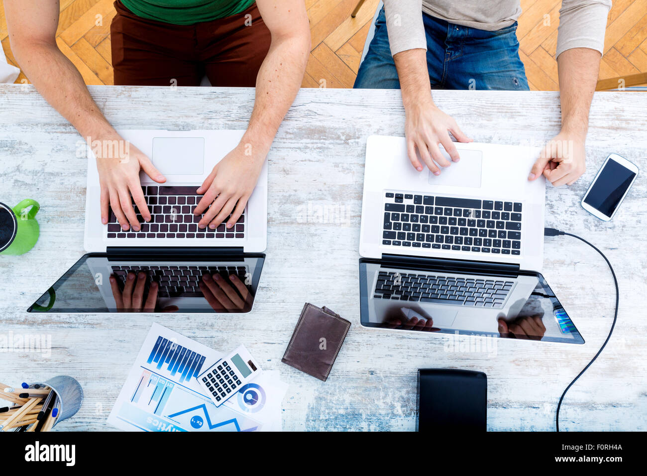 Two workmates teaming up and working together Stock Photo - Alamy